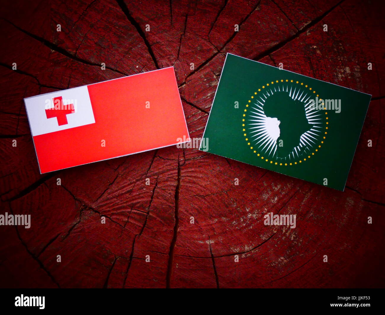 Tongan flag with African Union flag on a tree stump isolated Stock ...