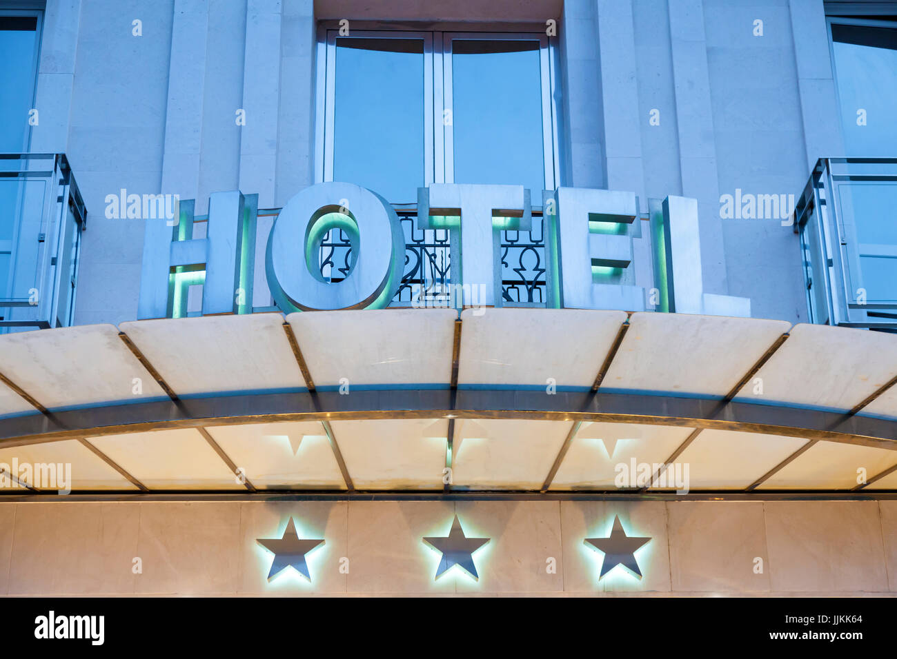 Three stars hotel facade illuminated at night Stock Photo - Alamy