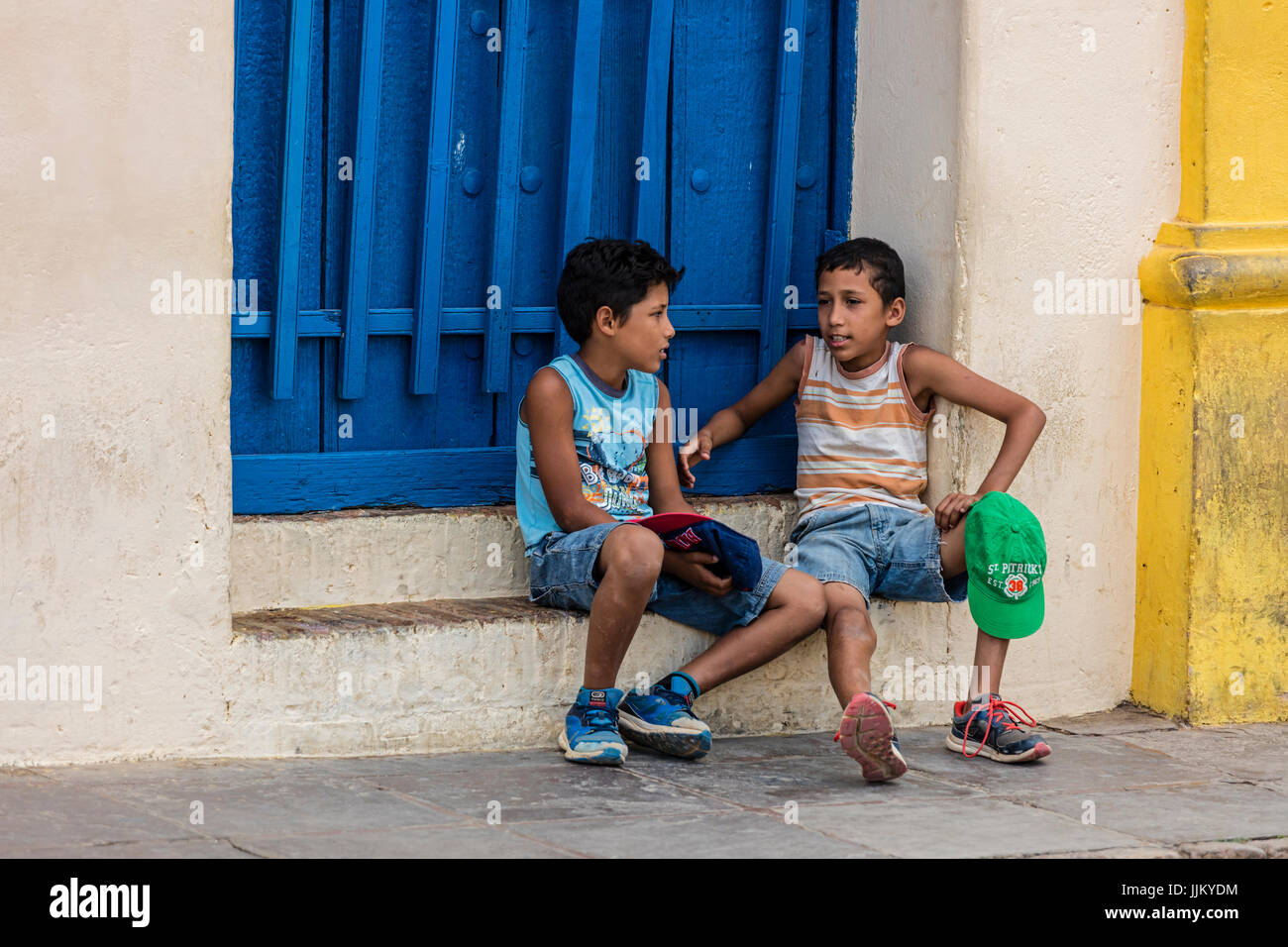 Young boys hand out in the PLAZA MAYOR - TRINIDAD, CUBA Stock Photo - Alamy
