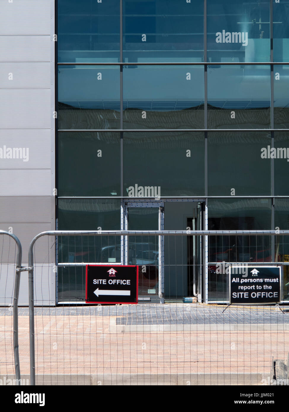 Site Office sign mounted on security fencing, new commercial warehouse ...