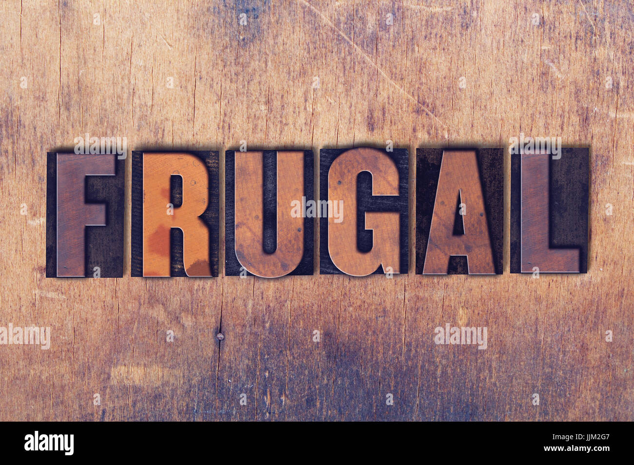 The word Frugal concept and theme written in vintage wooden letterpress ...