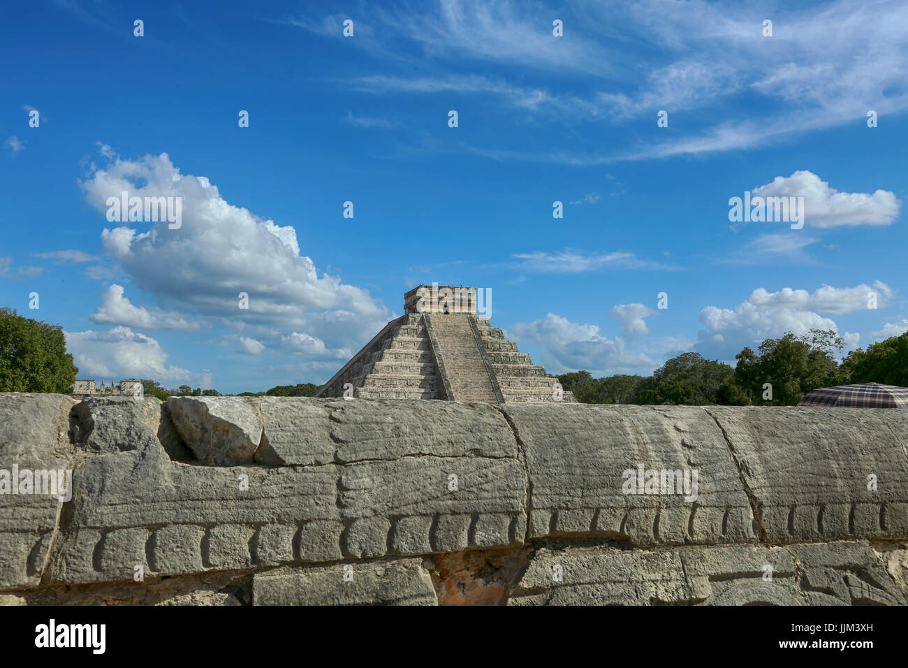 Kukulcan Mayan pyramid "El Castillo" with the sun rising from behind ...