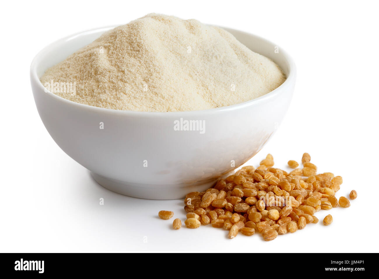 White flour in white ceramic bowl isolated on white. Next to spelt ...