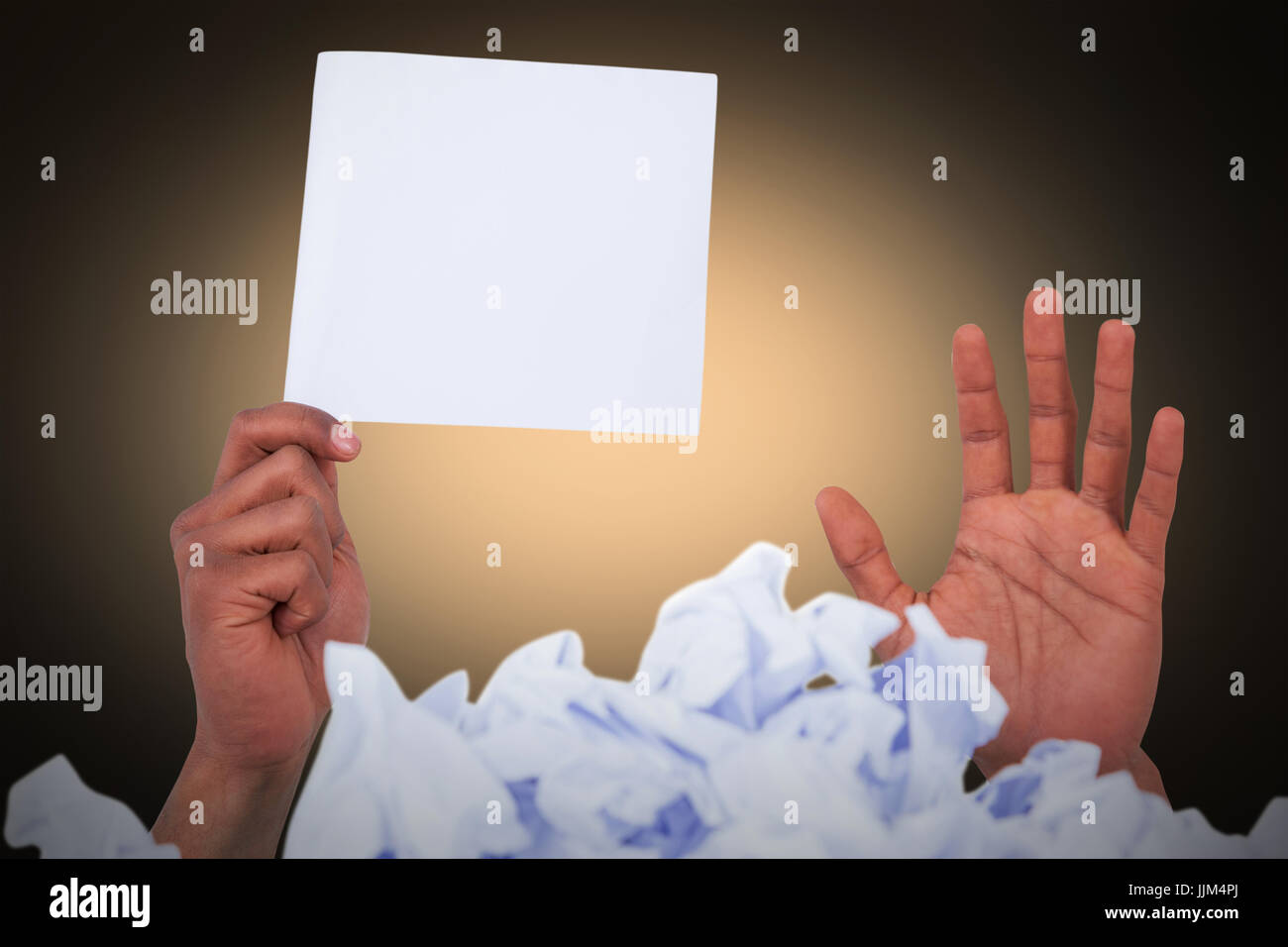 Composite image of heap of crumpled paper with hand holding blank page ...