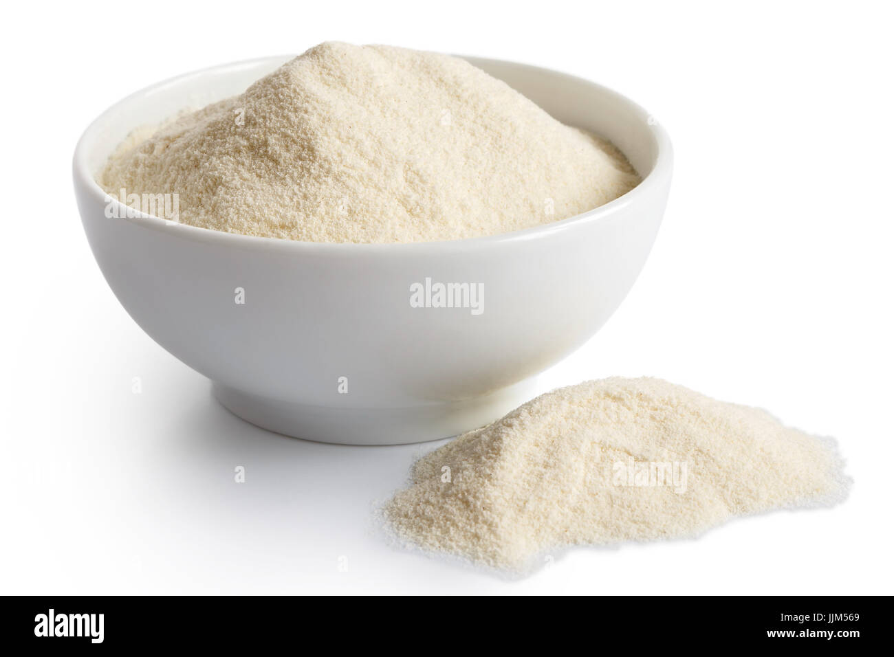 White flour in white ceramic bowl isolated on white. Spilled flour ...