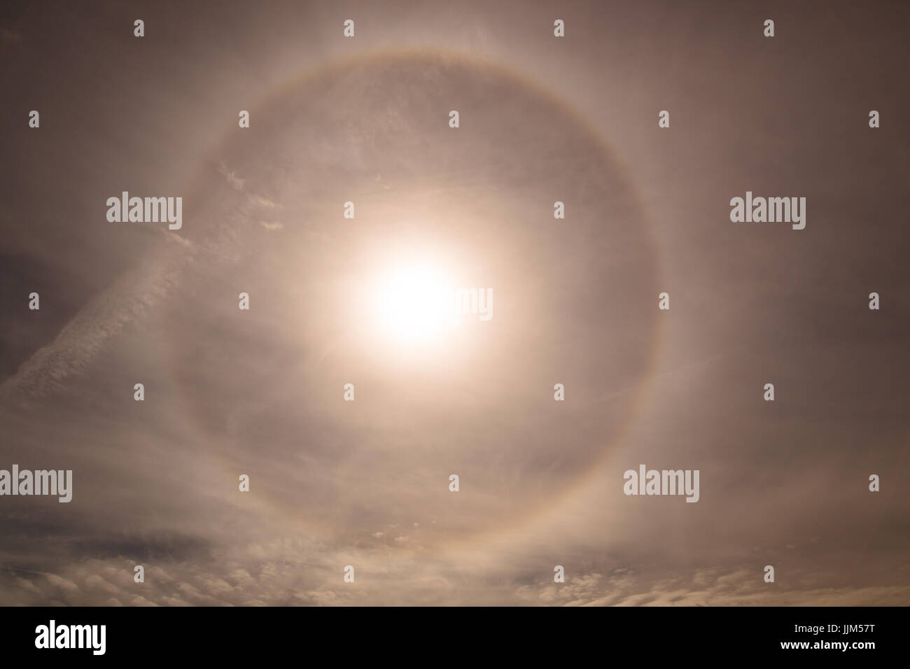 A strange refraction phenomenon around the sun with vapor trails ...