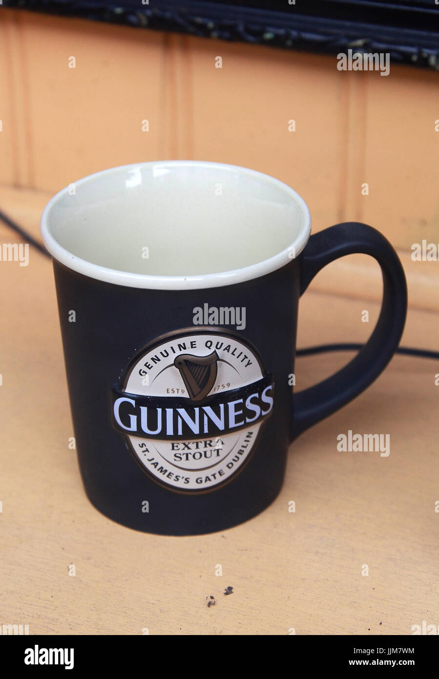 Guinness mug in a pub window Stock Photo - Alamy