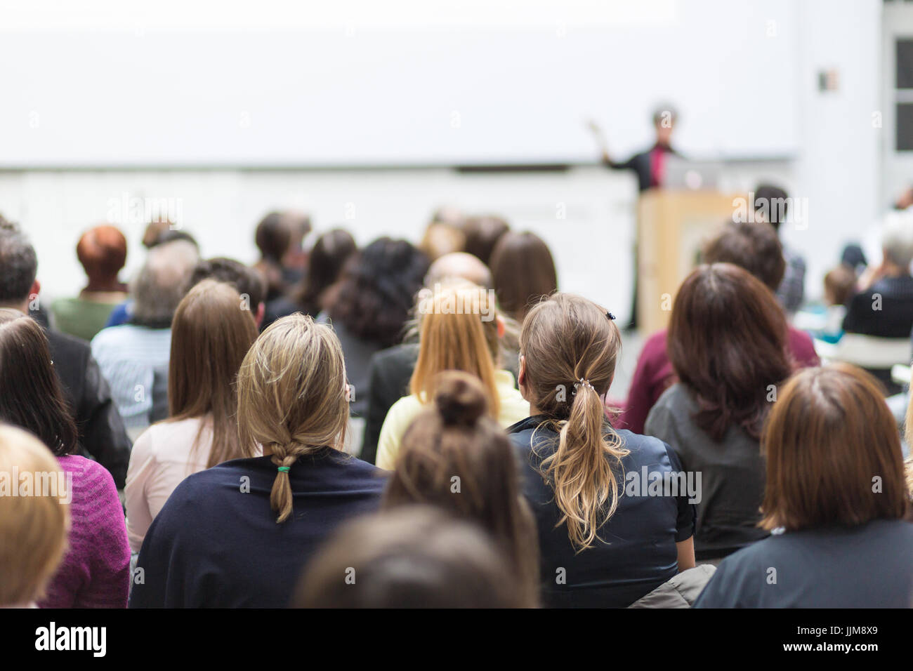 Woman giving presentation in lecture hall at university Stock Photo - Alamy