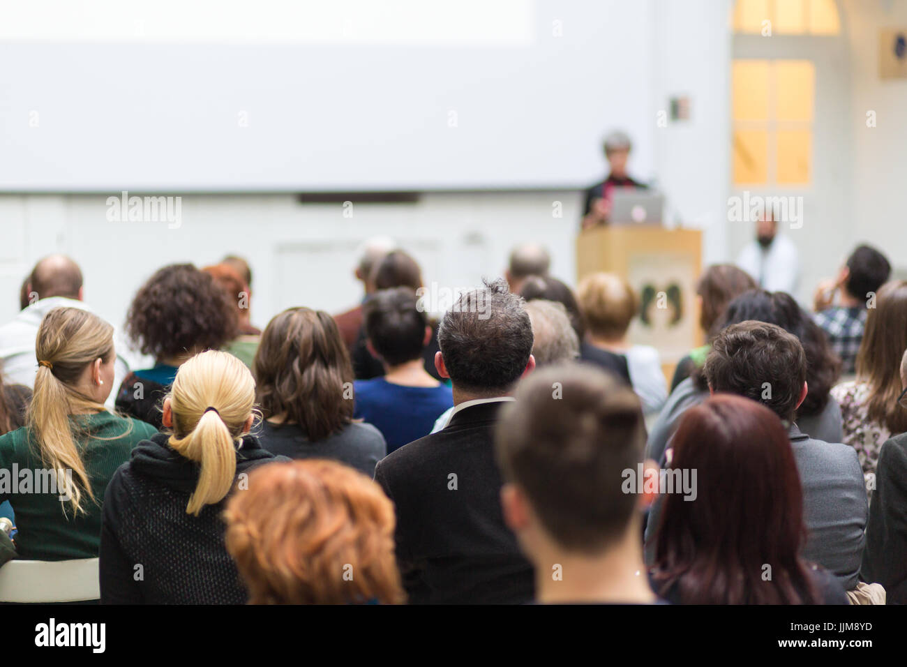 Woman giving presentation in lecture hall at university Stock Photo - Alamy