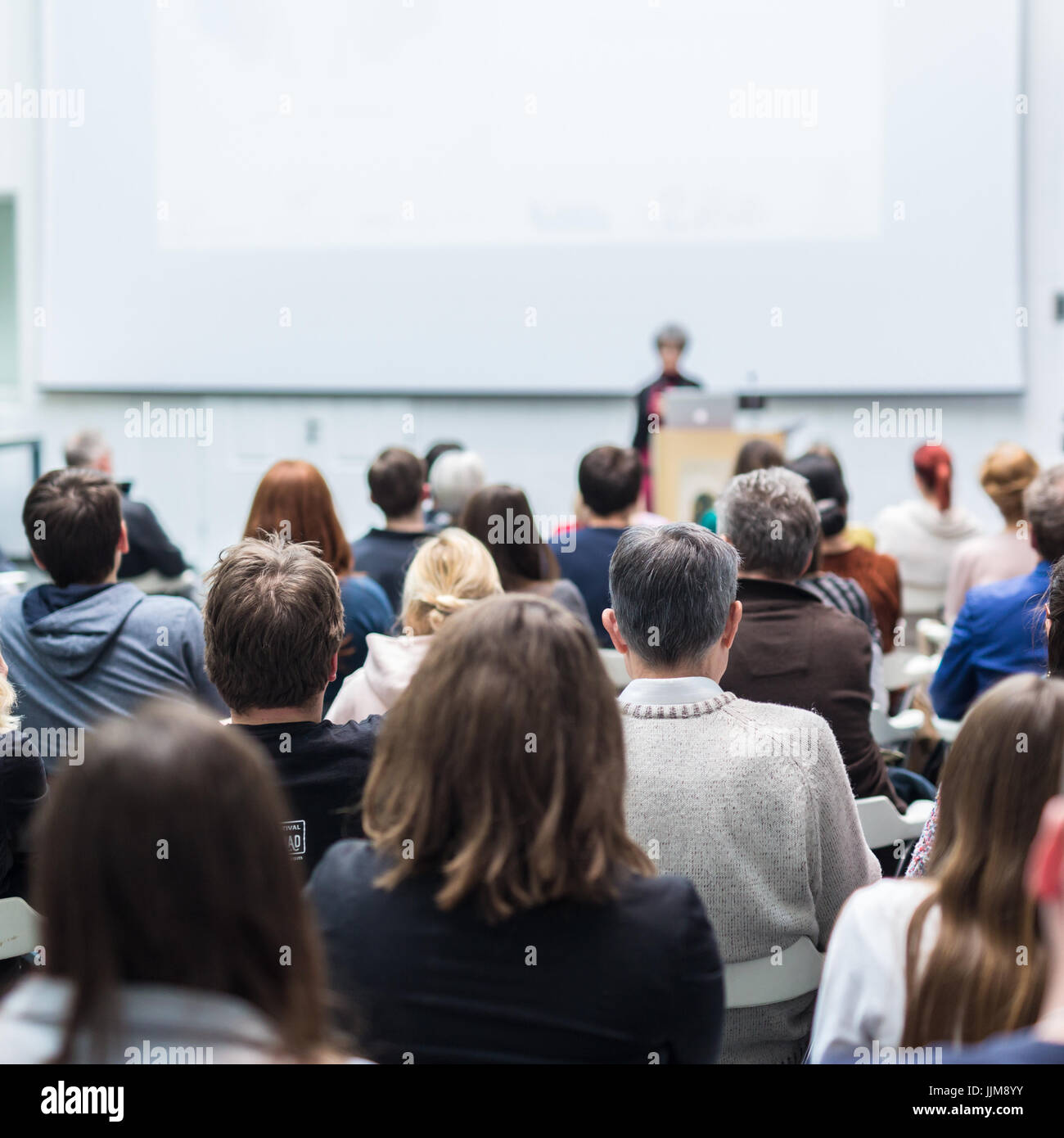 Woman giving presentation in lecture hall at university Stock Photo - Alamy