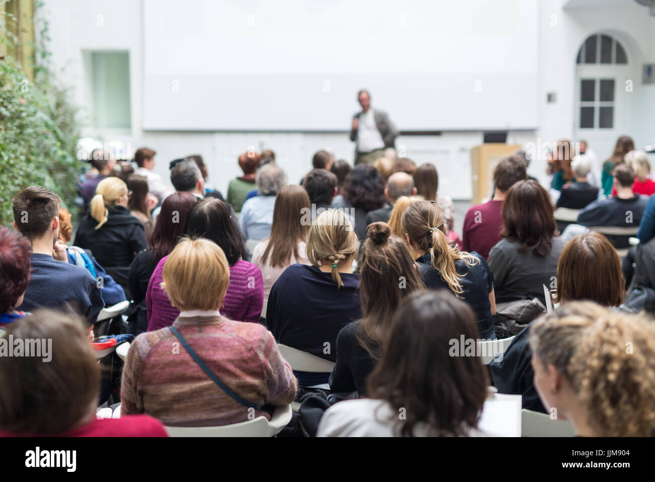 Man giving presentation in lecture hall at university Stock Photo - Alamy
