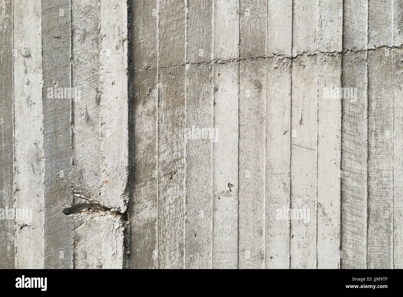 texture of wooden formwork stamped on a raw concrete wall as background ...