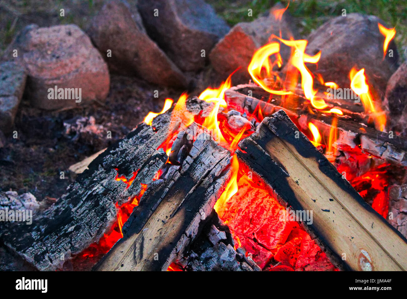 The perfect campfire with a ring of stones around it Stock Photo - Alamy