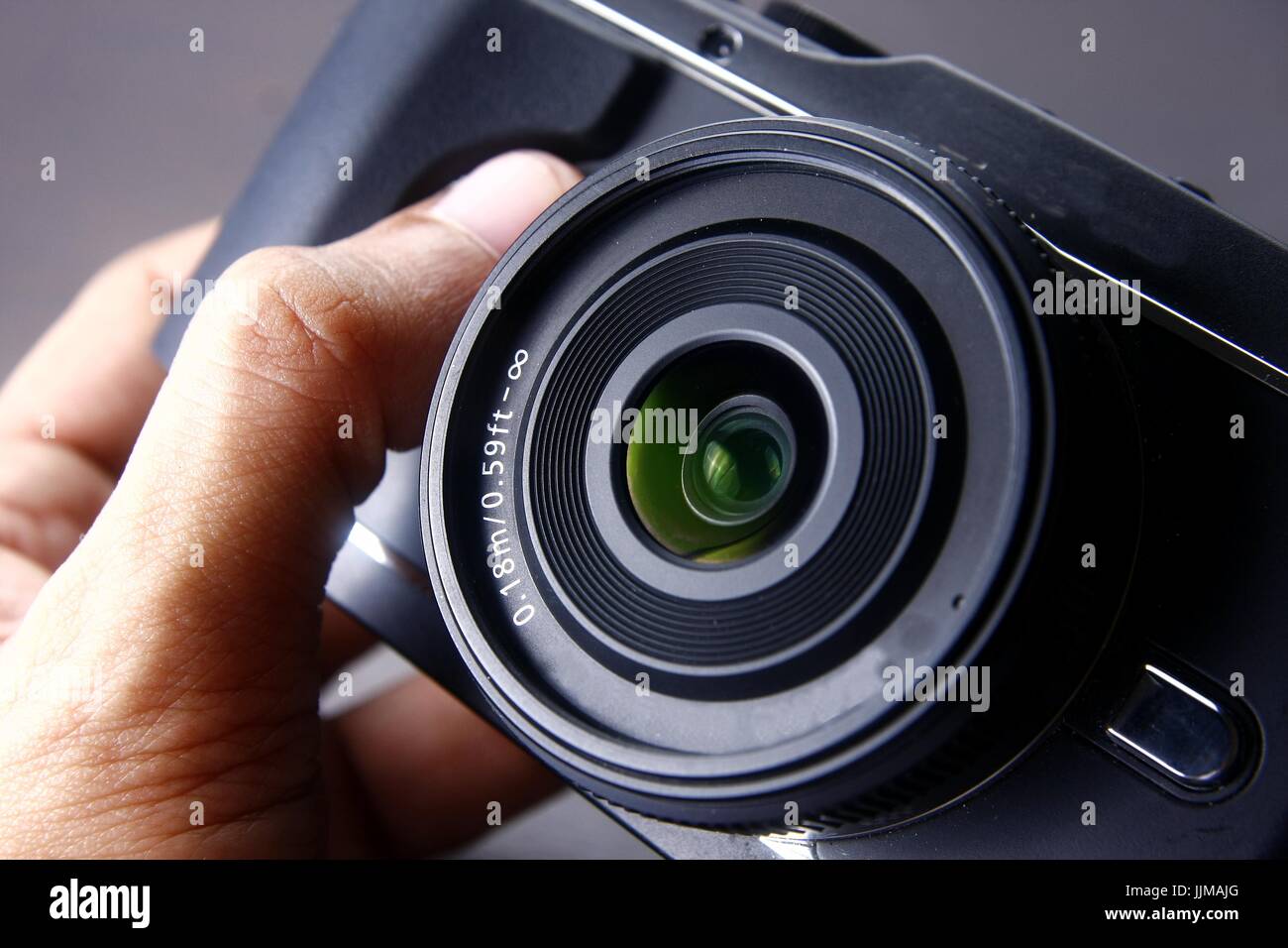 Photo of a hand holding a digital mirrorless camera Stock Photo - Alamy