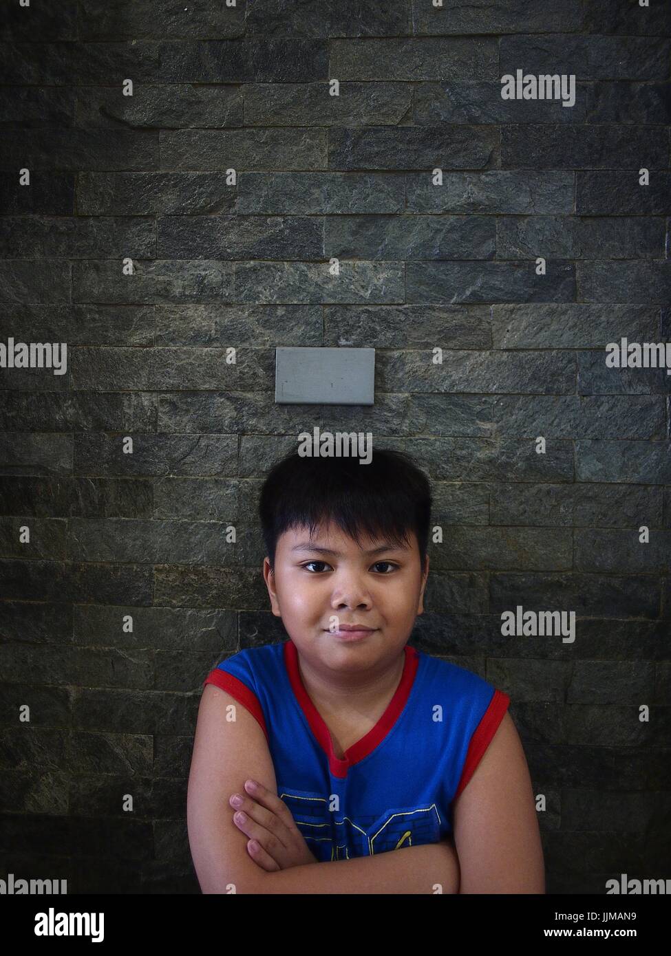 Portrait of a young boy leaning against a stone wall Stock Photo - Alamy Portrait of a young boy leaning against a stone wall Stock Photo - Alamy