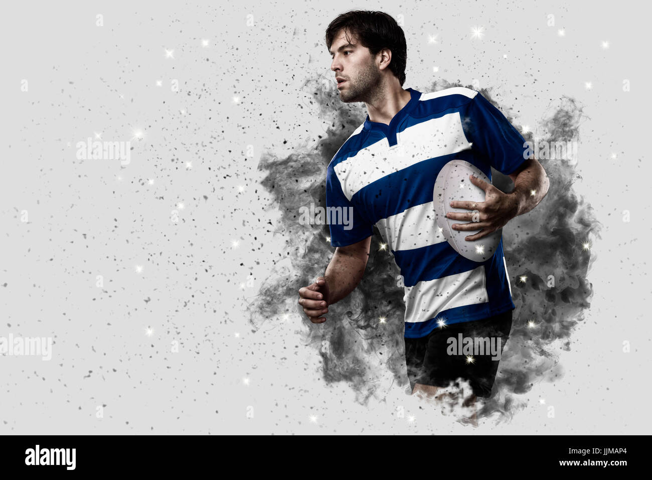 Rugby Player with a blue uniform coming out of a blast of smoke Stock ...