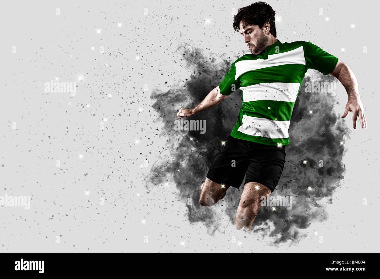 Rugby Player with a green uniform coming out of a blast of smoke Stock ...