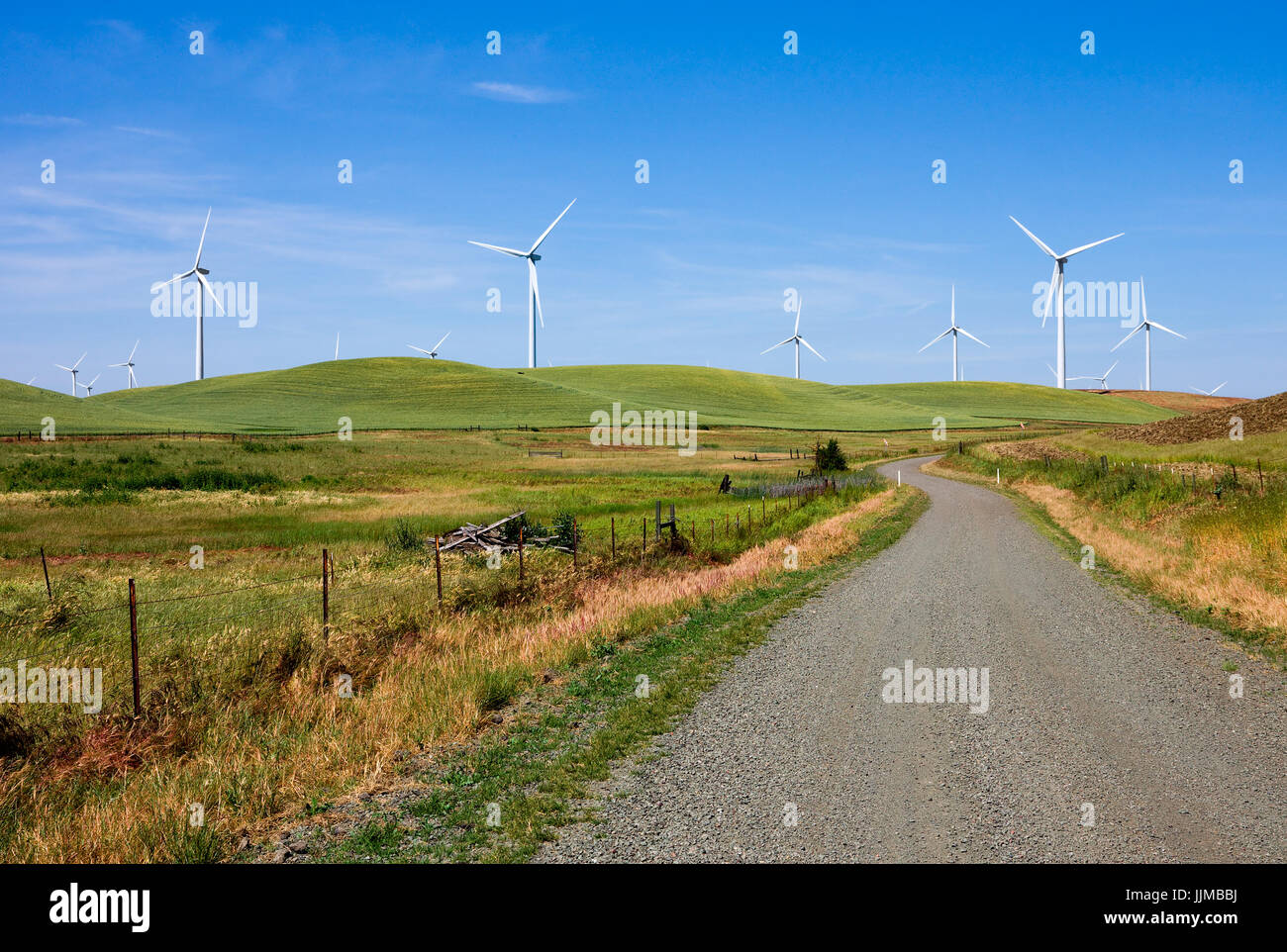 Road through wind turbines farm Stock Photo - Alamy
