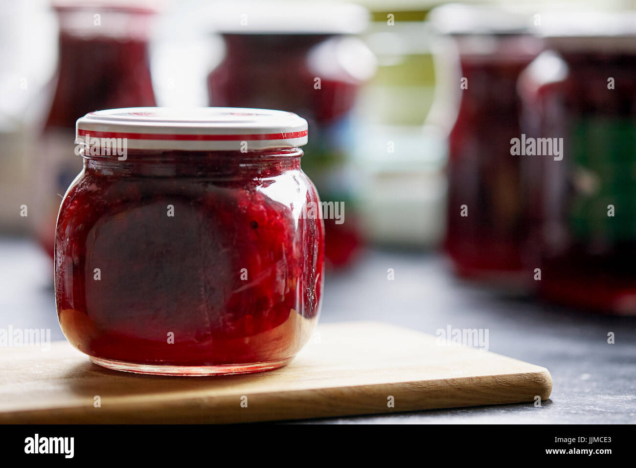 Transparent jar with red jam Stock Photo - Alamy