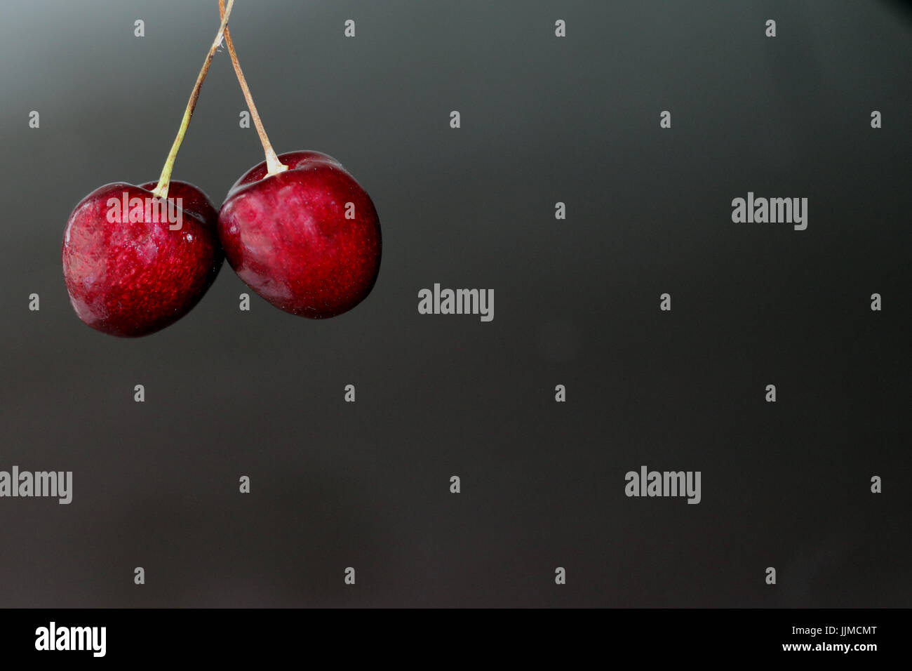 cherry background,focus at cherry on black background Stock Photo - Alamy