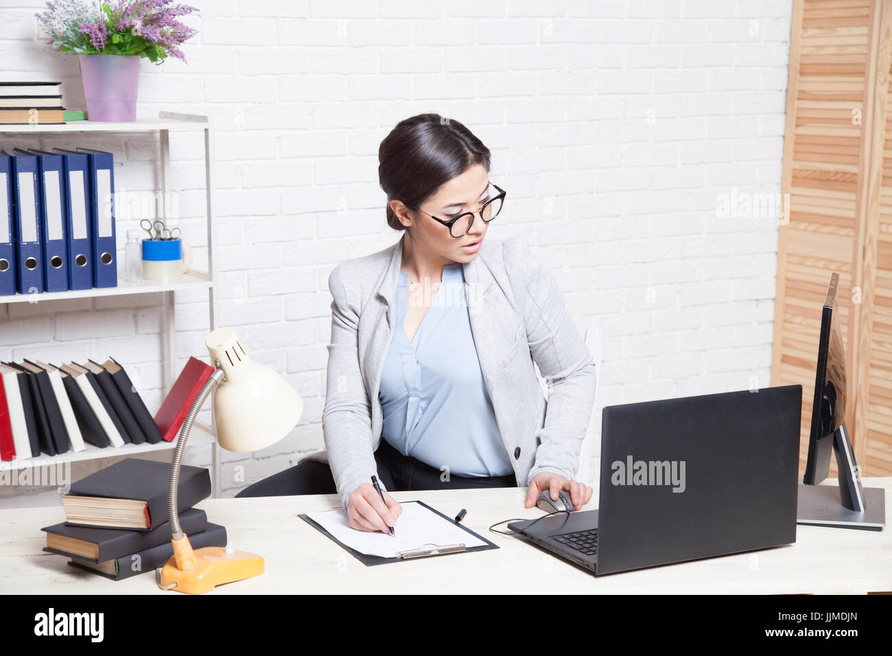 Lovely young woman works hi-res stock photography and images - Alamy