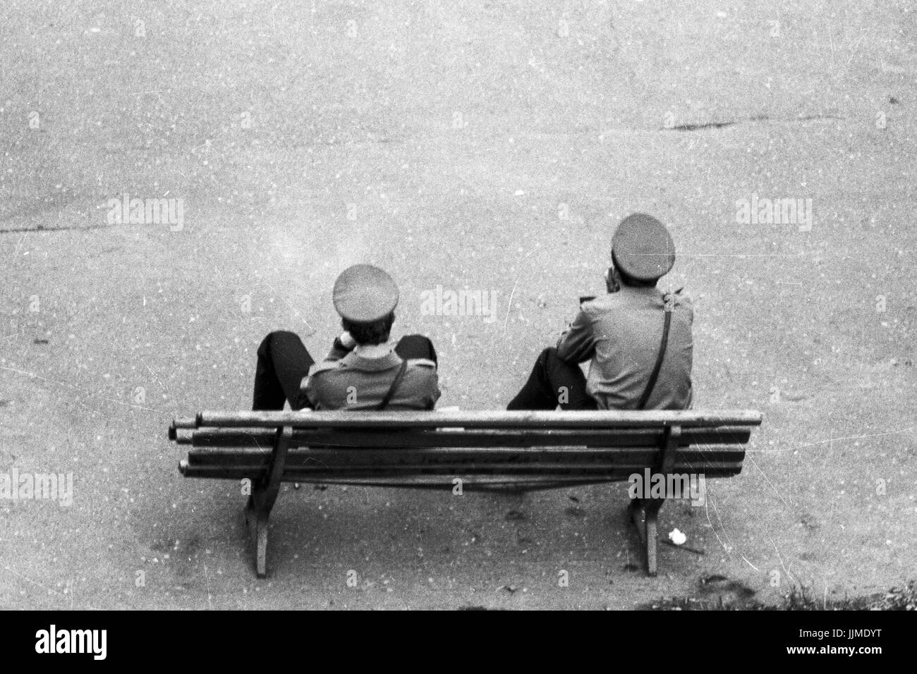 Two thinking police officers (milicja), sitting on the bench, Communism ...