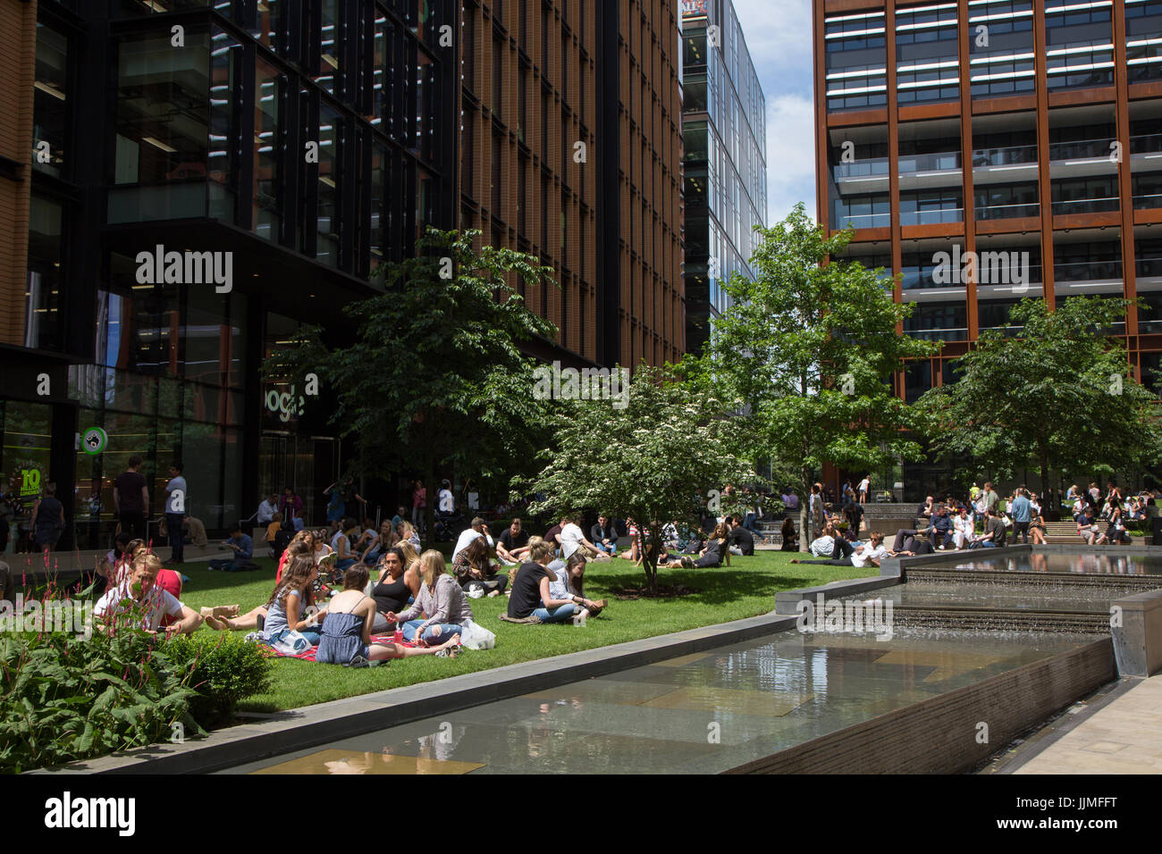 Employees from offices spill out for lunch on grass at Battle Bridge ...