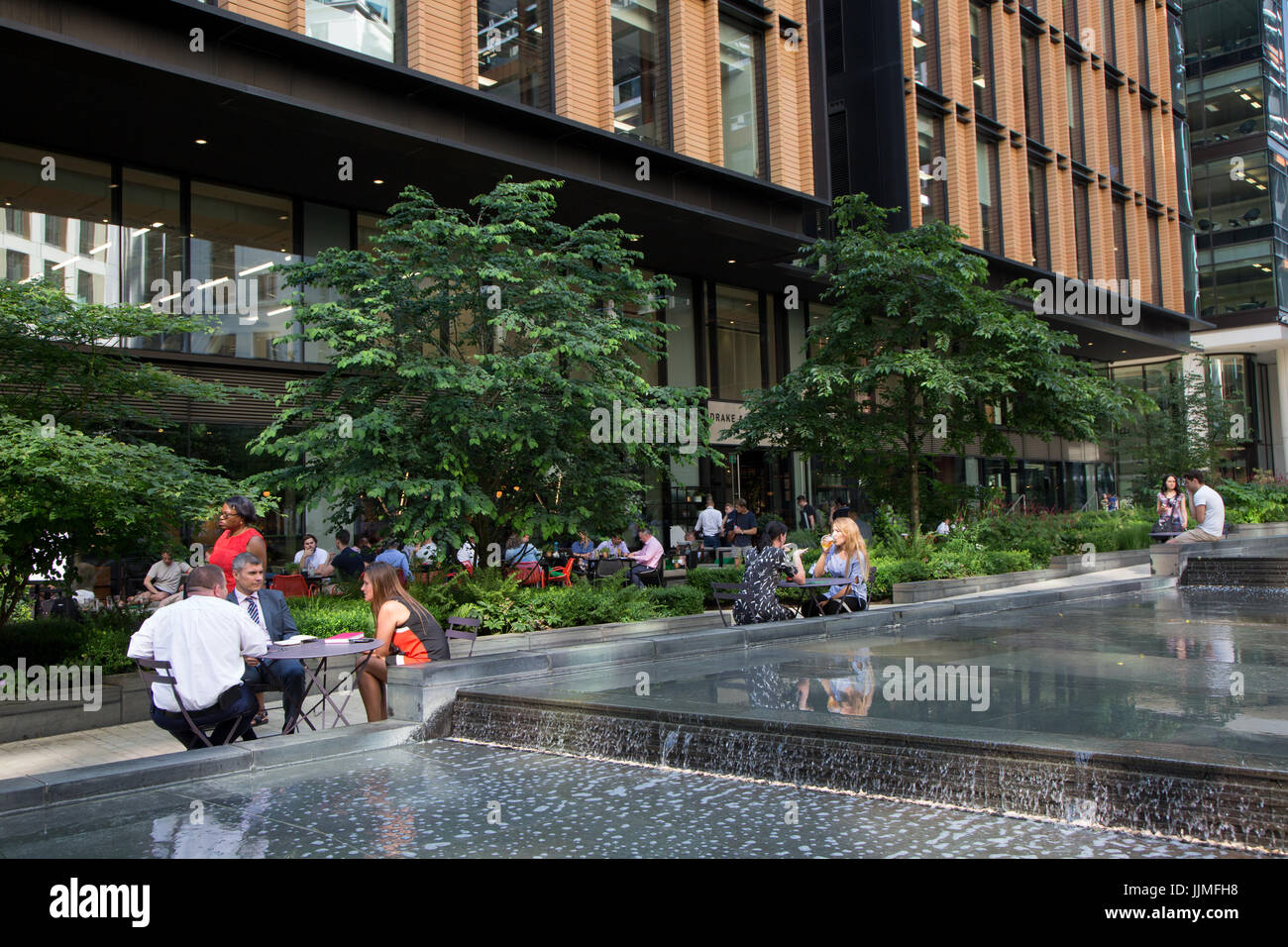 Employees from offices spill out for lunch on grass at Battle Bridge ...
