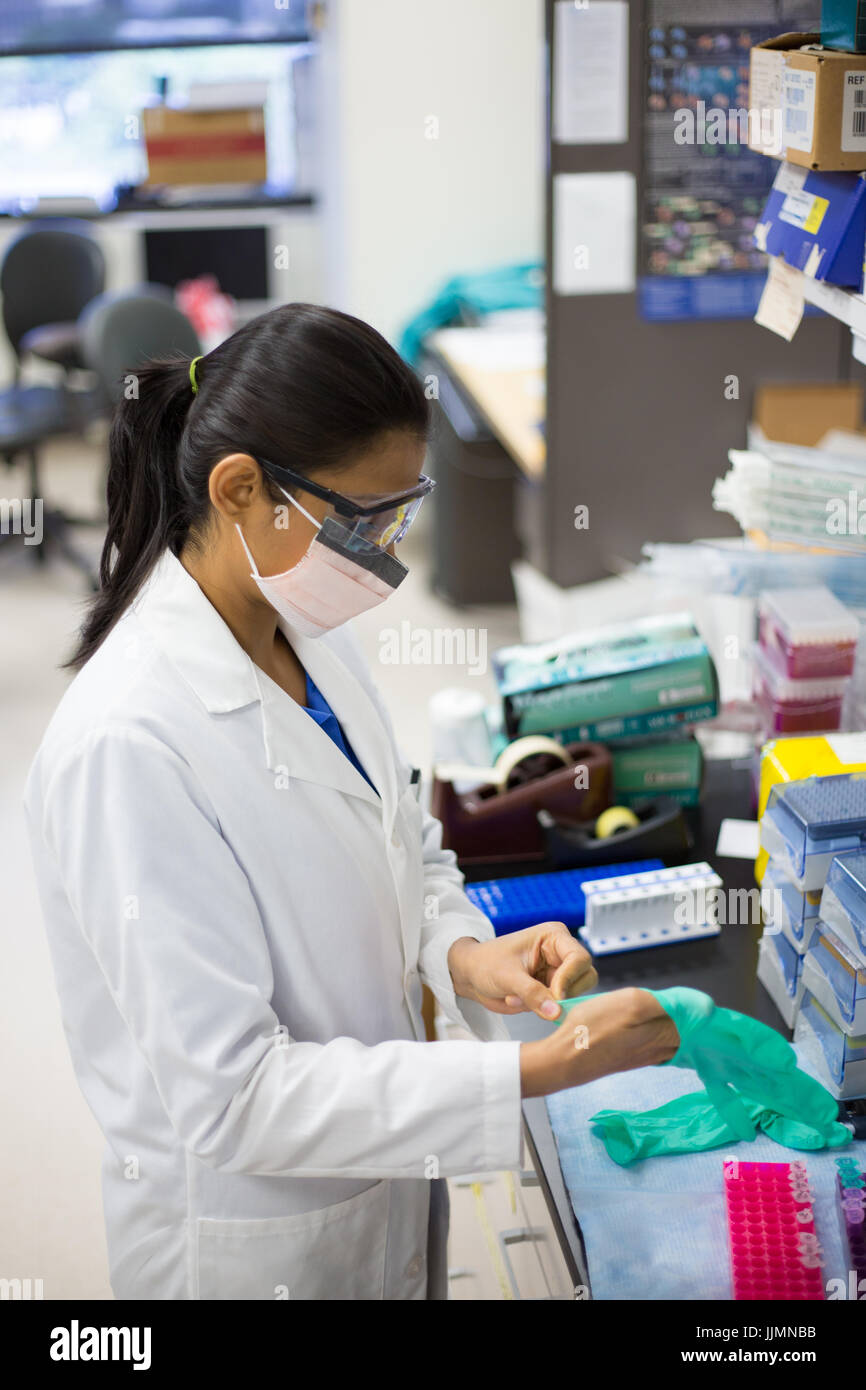 Closeup portrait, young scientist in labcoat doing experiments in lab ...