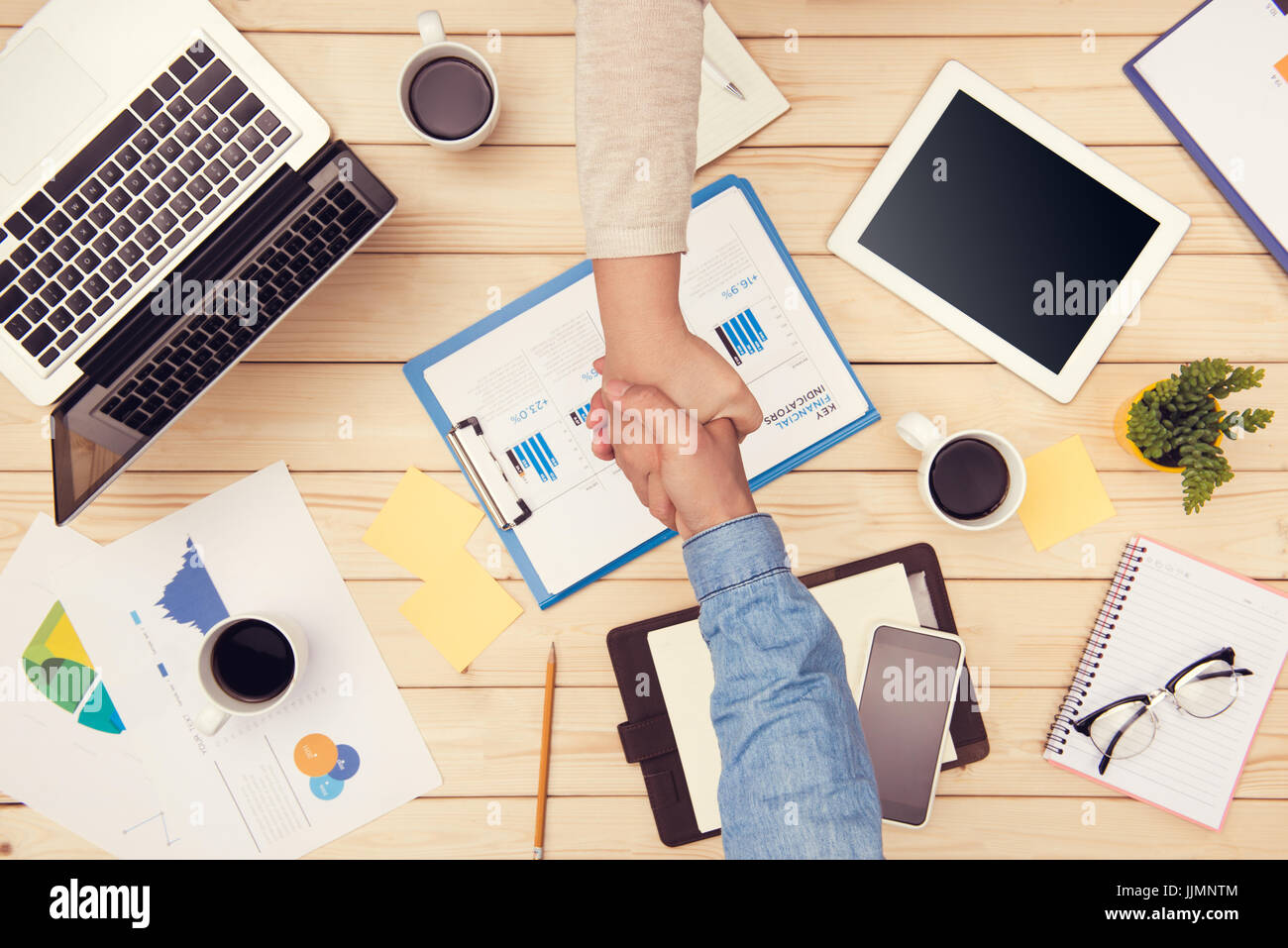 Confident business handshake. Top view of two business people shaking ...