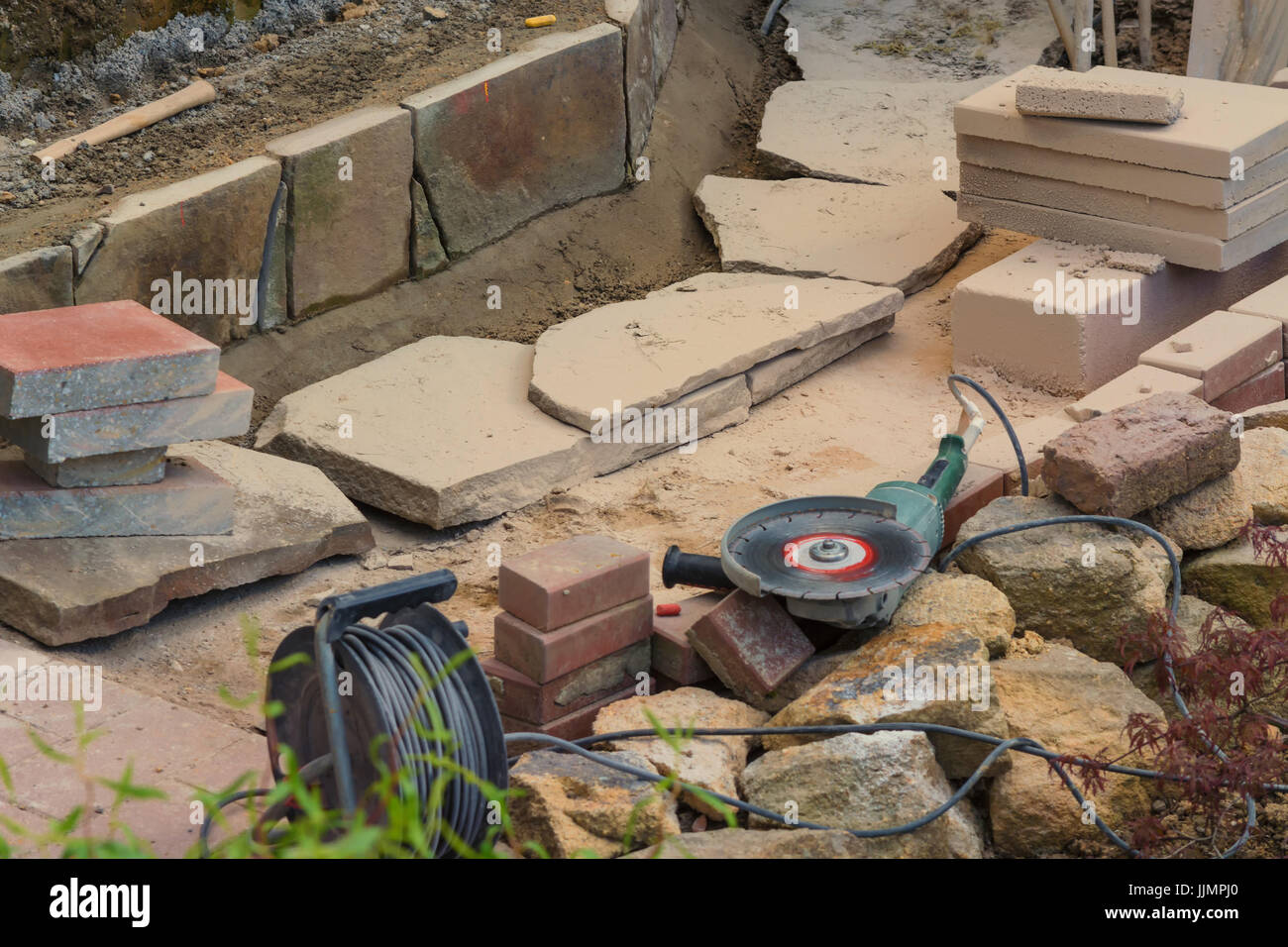Man cutting stone slabs, concrete slab with an electric grinder Stock ...