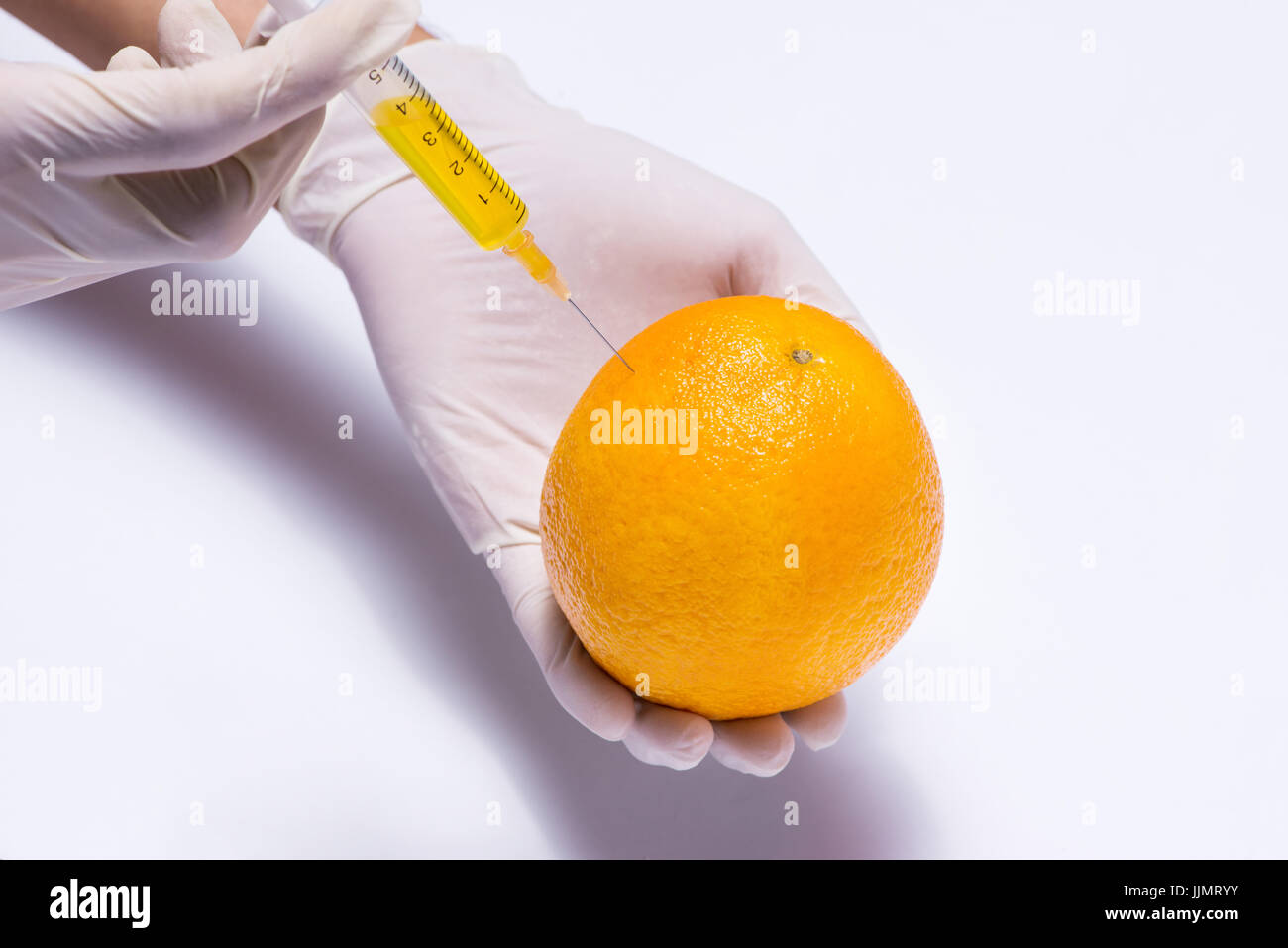 Science experiment with orange and syringe isolated on white Stock ...