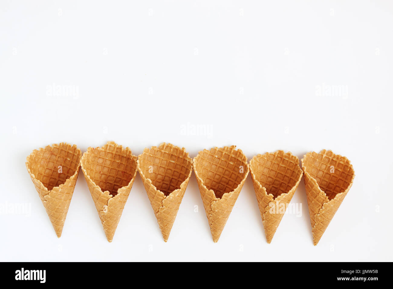 Several waffle cones lined in tower, smile, or even row, top view ...