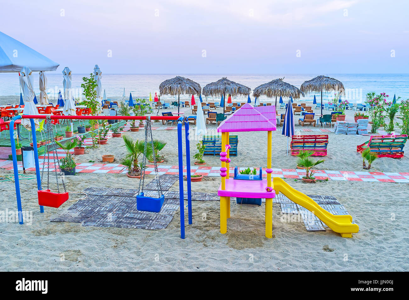 The chidren's playground with swing in sandy Kleopatra beach is ...