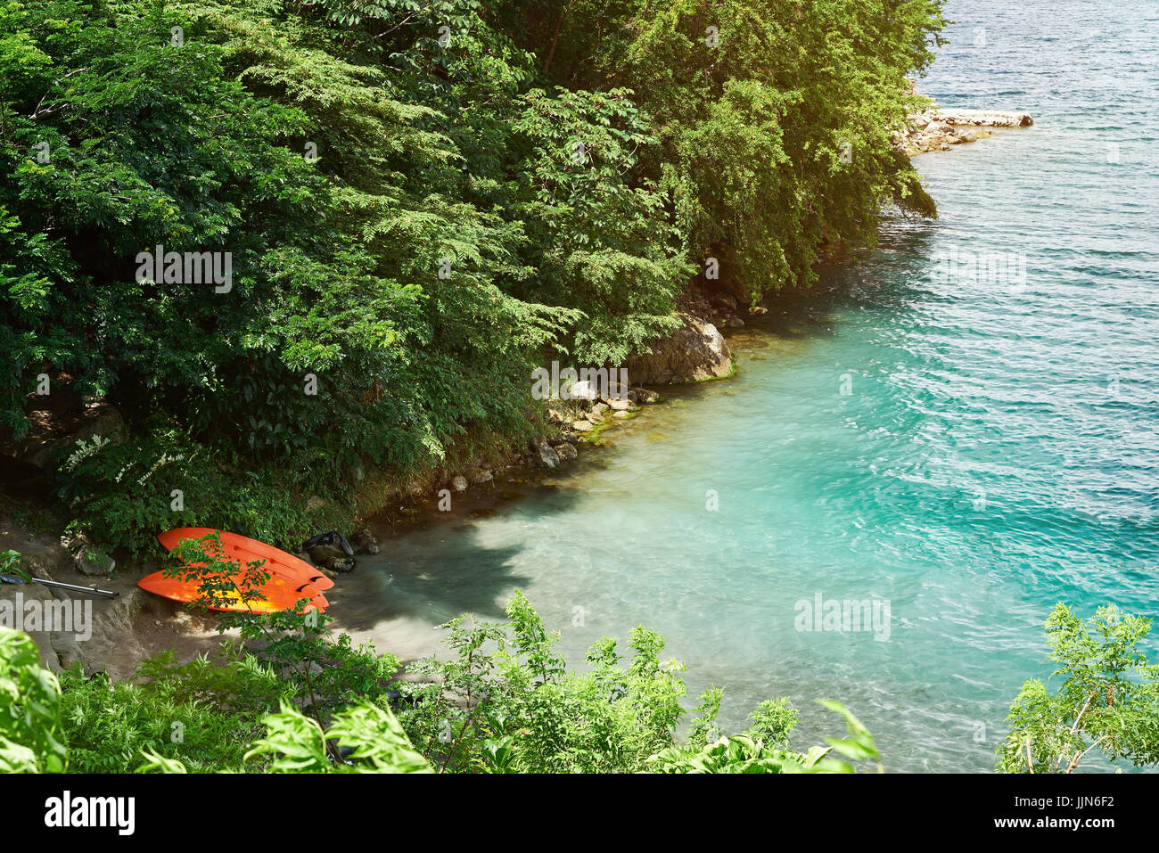 Blue lagoon bay with kayak on beach. Nobody in small lagoon water Stock ...