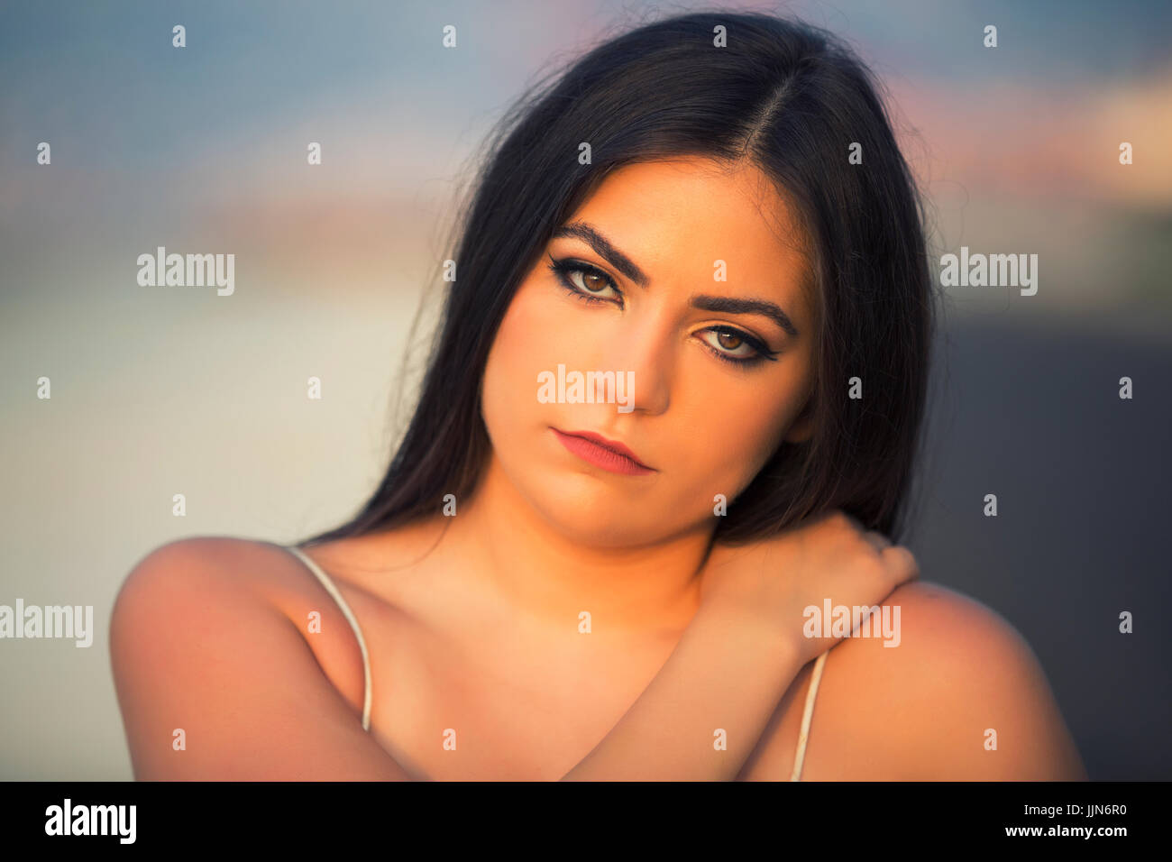 Sewrious young woman hand touching shoulder outdoors staring Stock ...