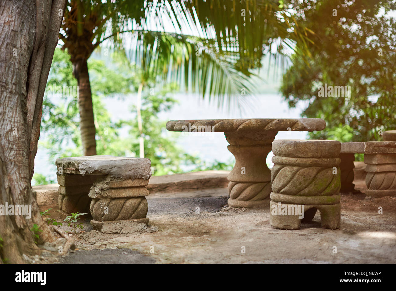 Patio with stone furniture on beach background Stock Photo - Alamy