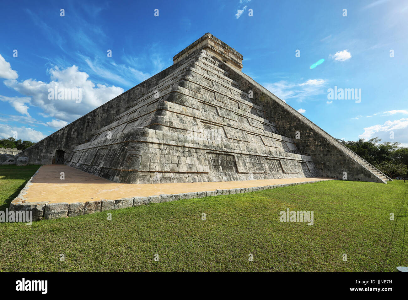Kukulcan Mayan pyramid "El Castillo" with the sun rising from behind ...