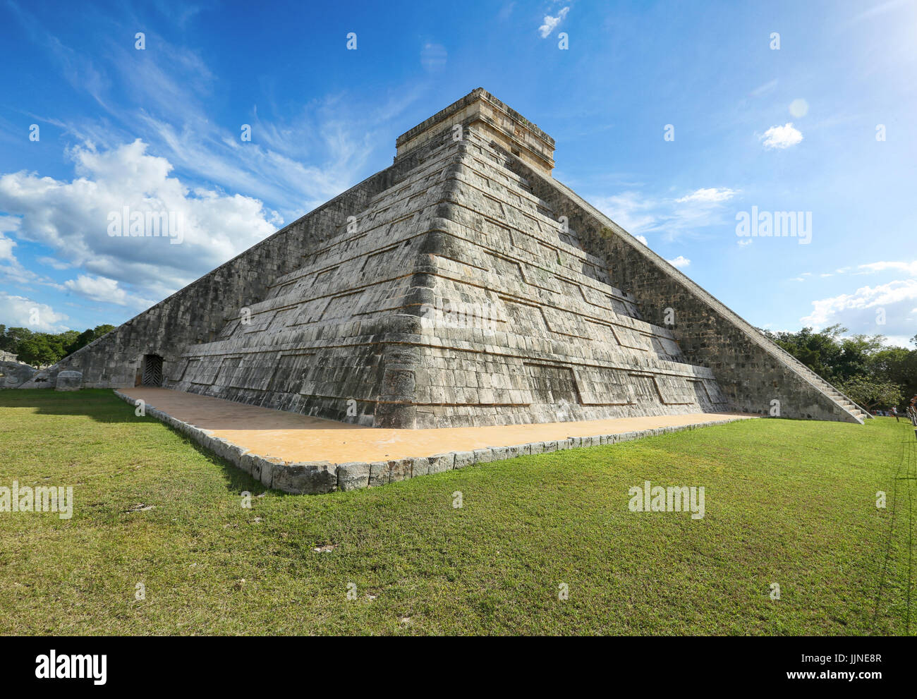 Kukulcan Mayan pyramid "El Castillo" with the sun rising from behind ...