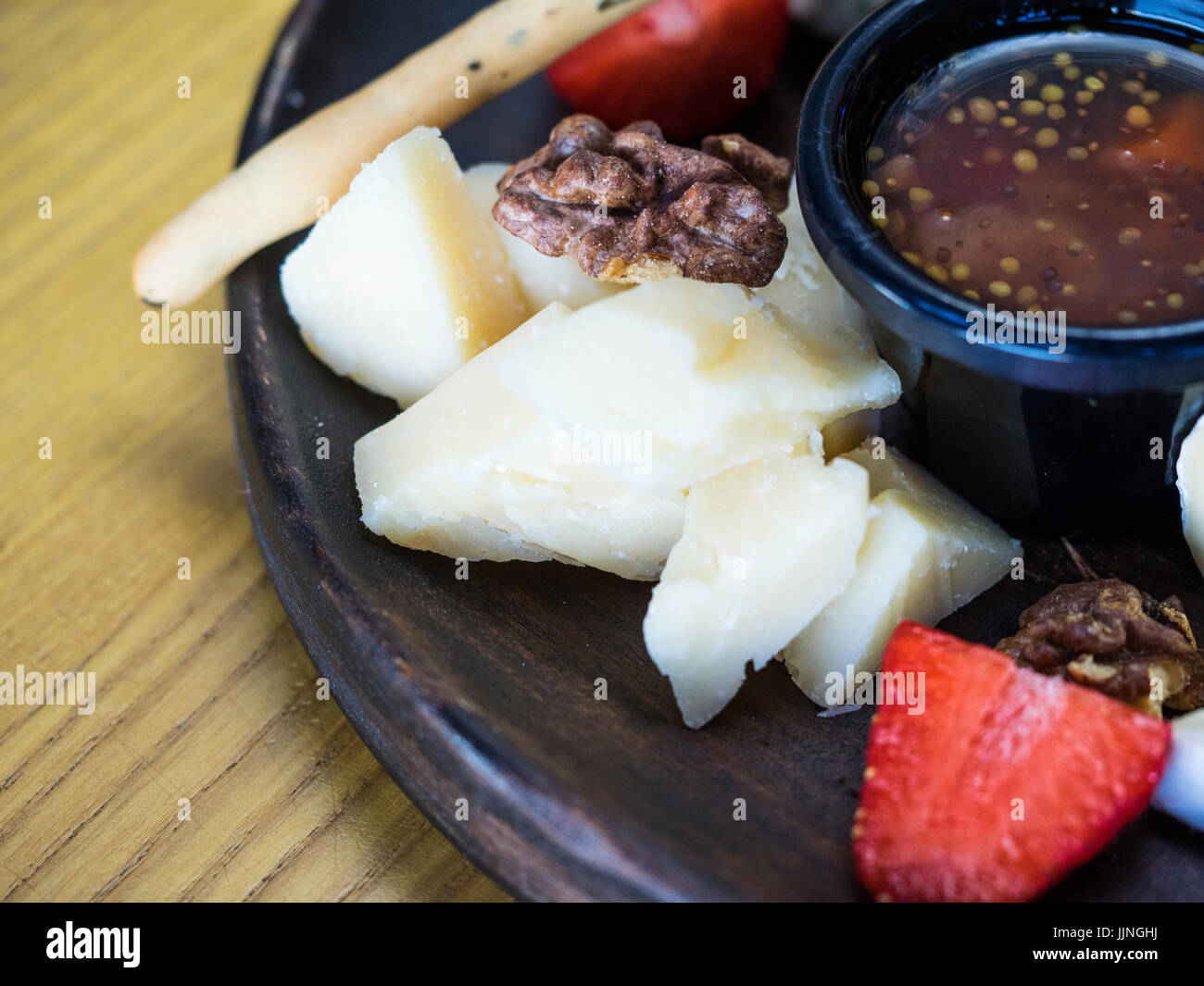 Italian chesse plate on black dish Stock Photo - Alamy