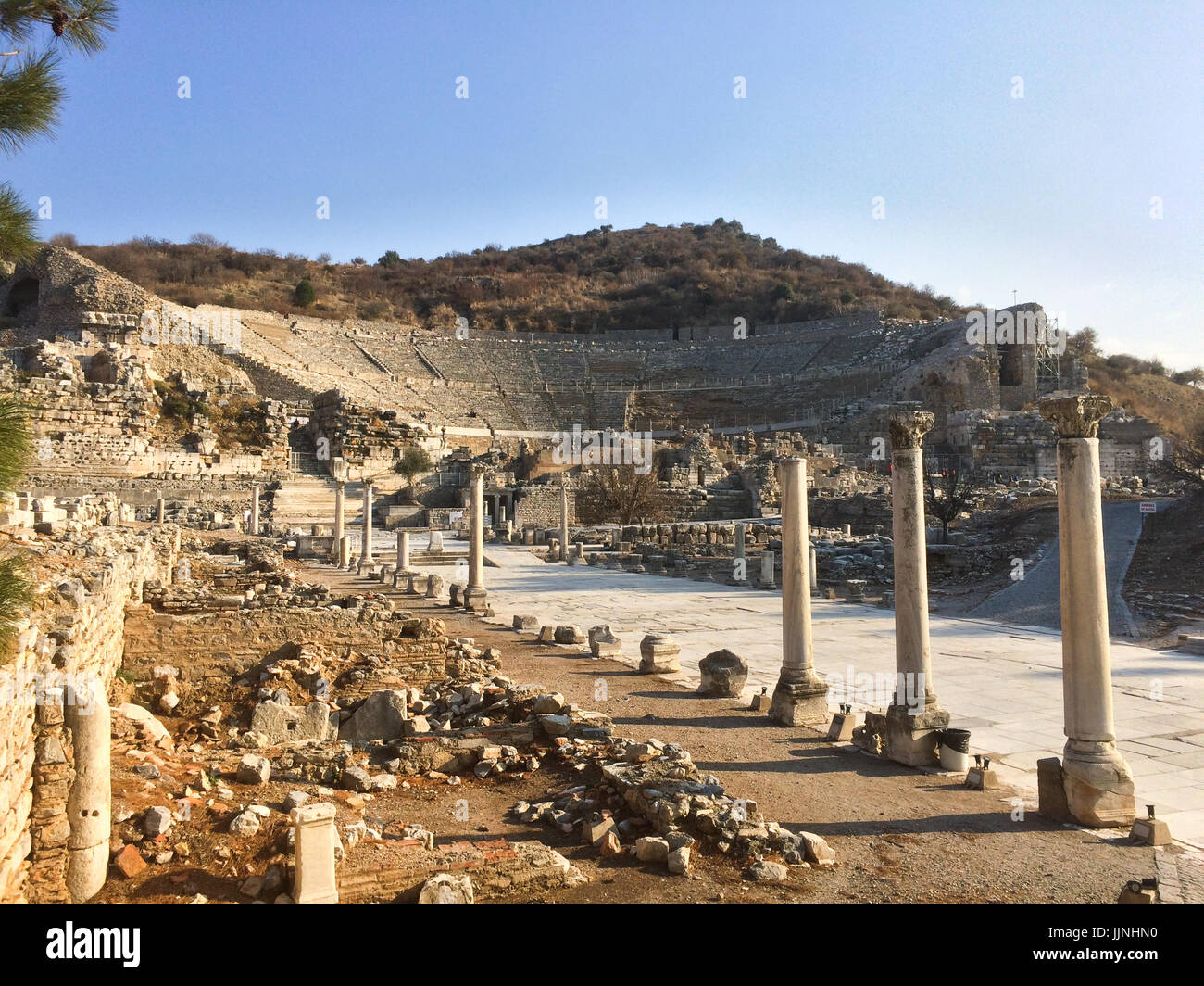 Roman stone road with pillars to amphitheater ruins in Ephesus ...