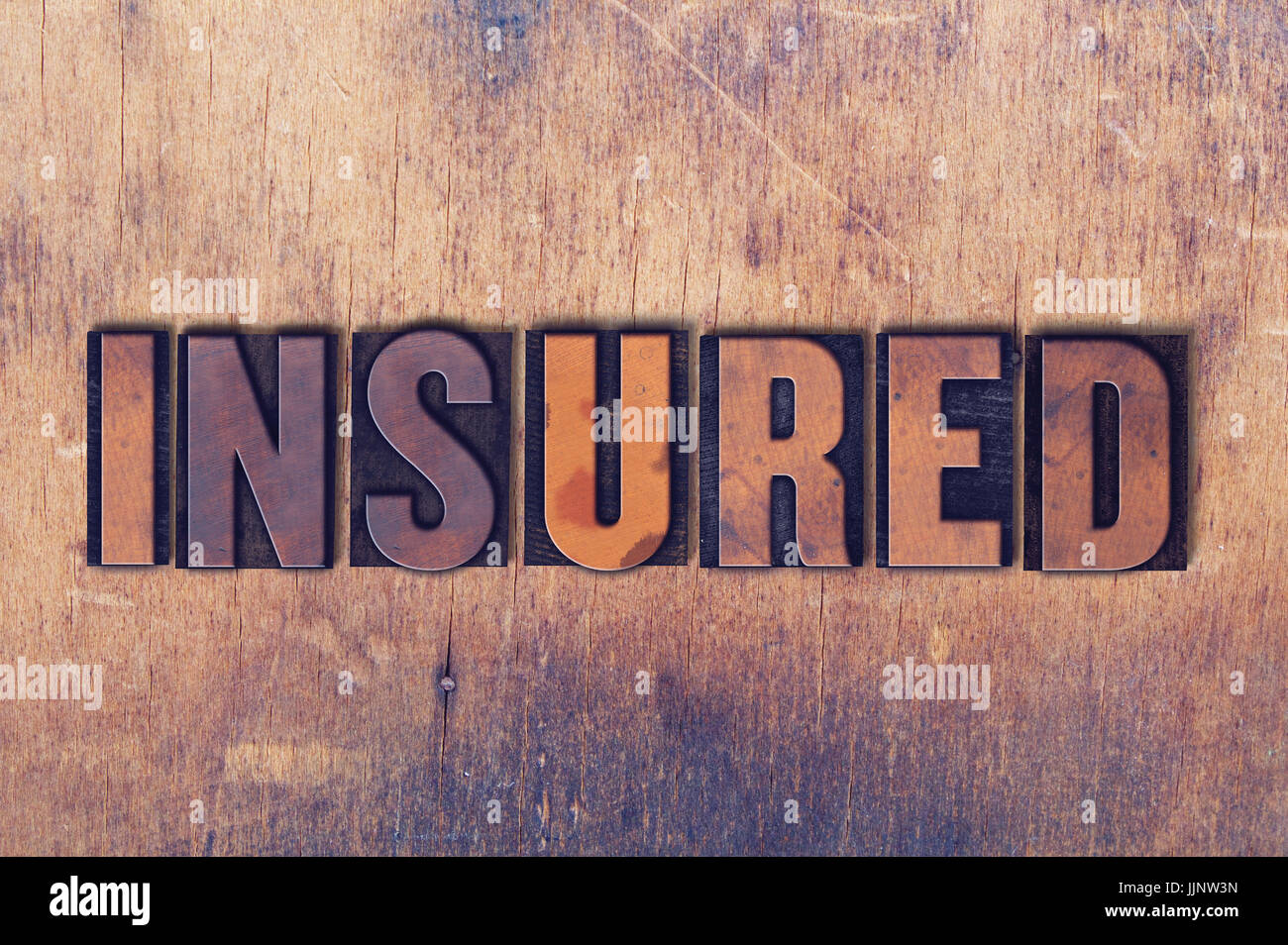 The word Insured concept and theme written in vintage wooden ...