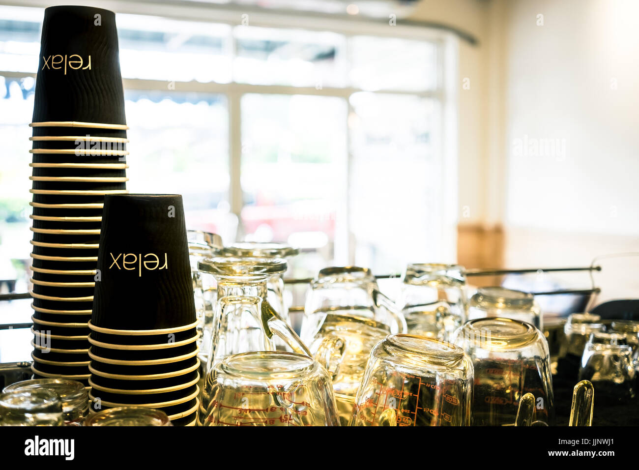 paper coffee cup in coffee shop background Stock Photo - Alamy