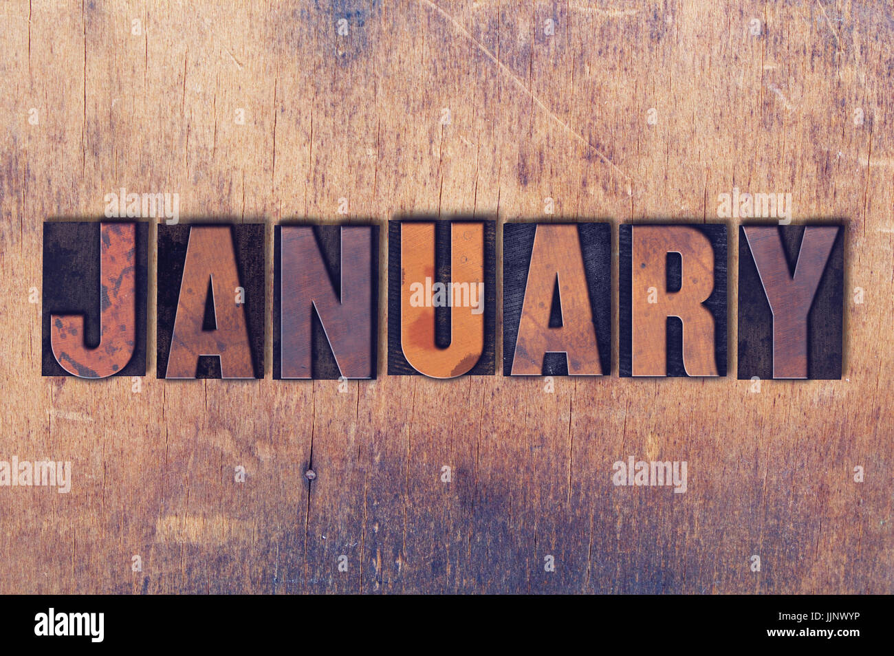 The word January concept and theme written in vintage wooden ...
