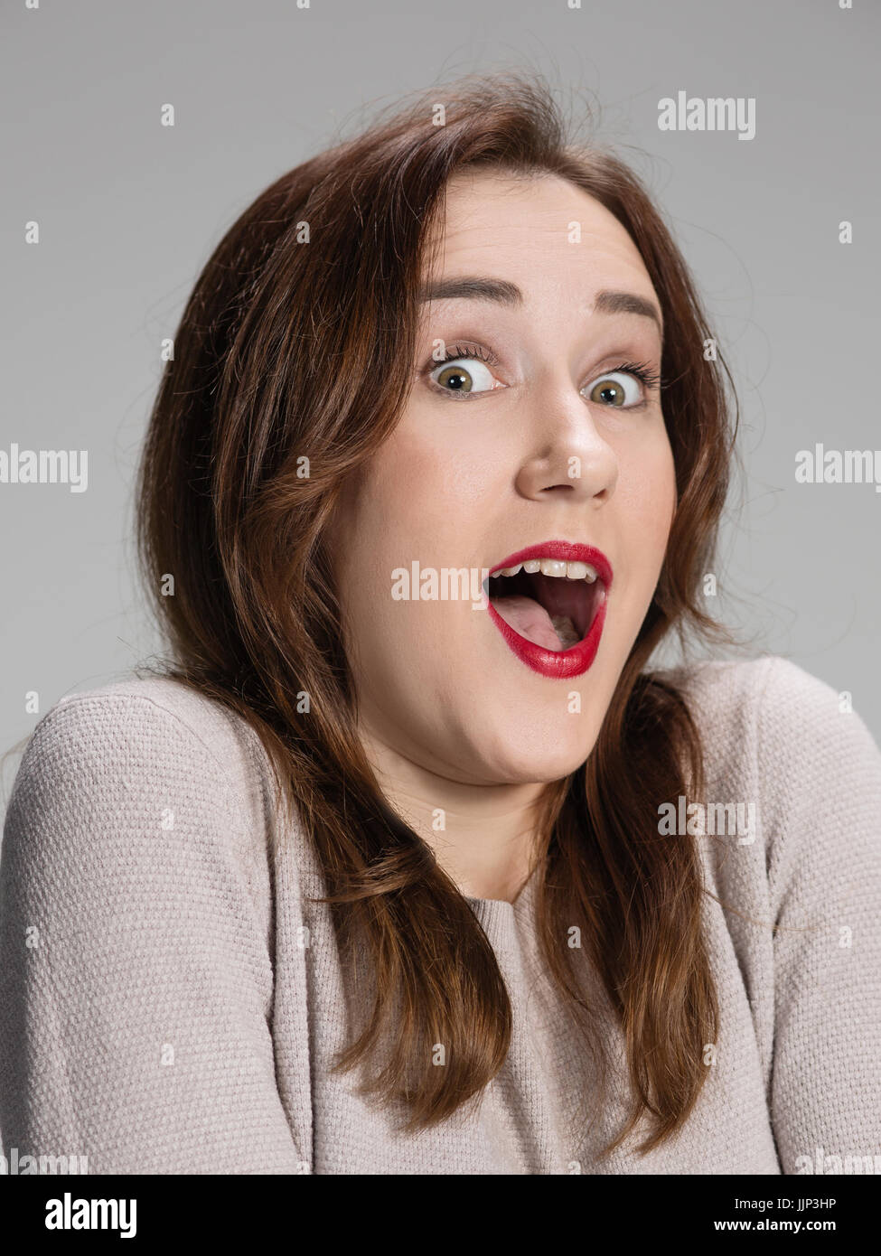 Portrait of young woman with shocked facial expression Stock Photo - Alamy