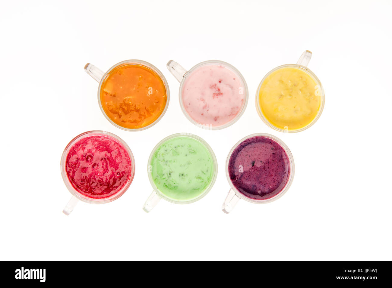 Top view of fresh fruit smoothies in glass cups isolated on white Stock ...