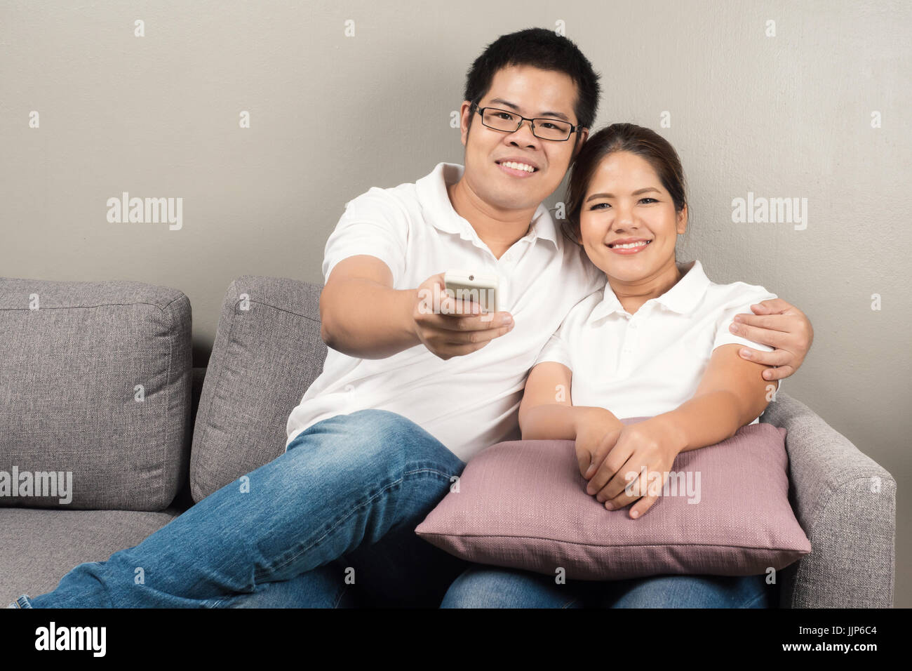 Happy asian family watching tv hi-res stock photography and images - Alamy
