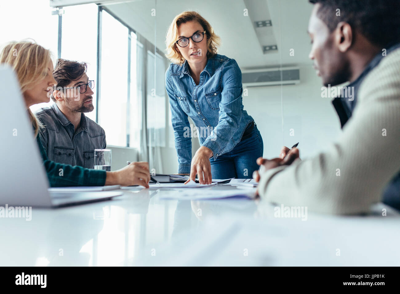 Businesswoman standing and leading business presentation. Female ...