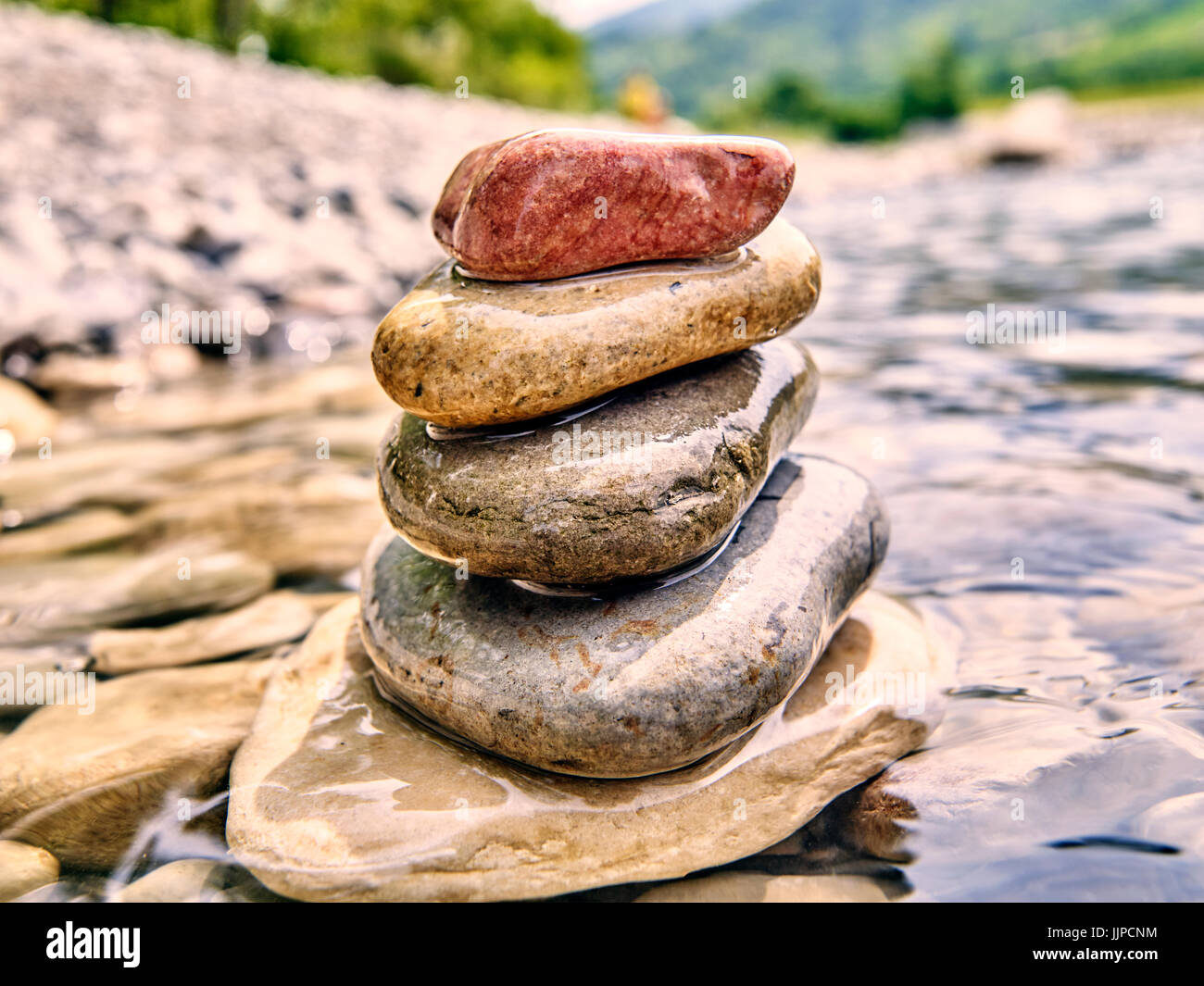 rocks, river pebbles stacked in a stream Stock Photo - Alamy