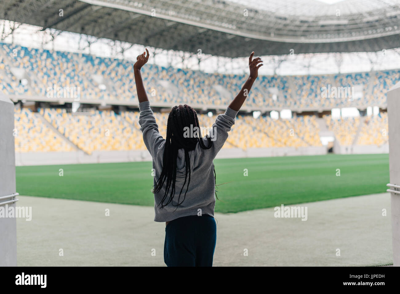 African american person raising hands hi-res stock photography and ...